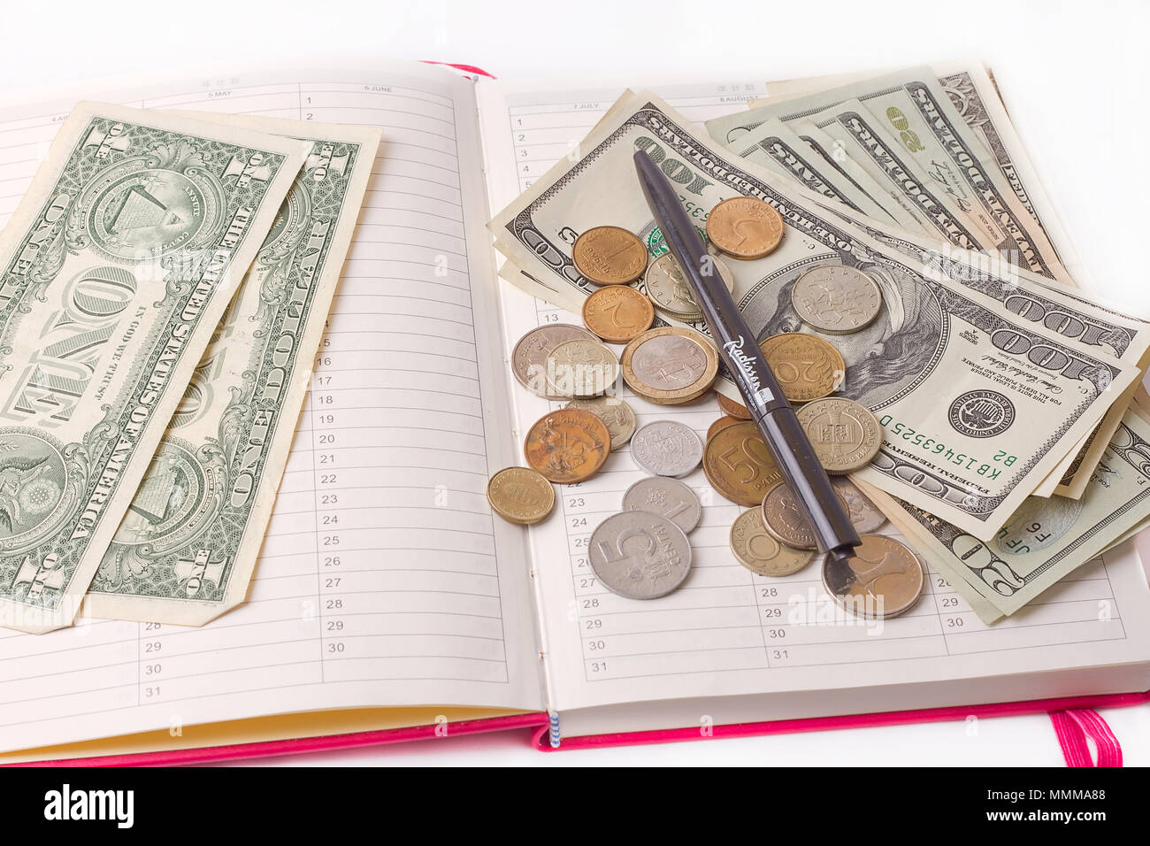 Diary with money and pen isolated on white background Stock Photo - Alamy