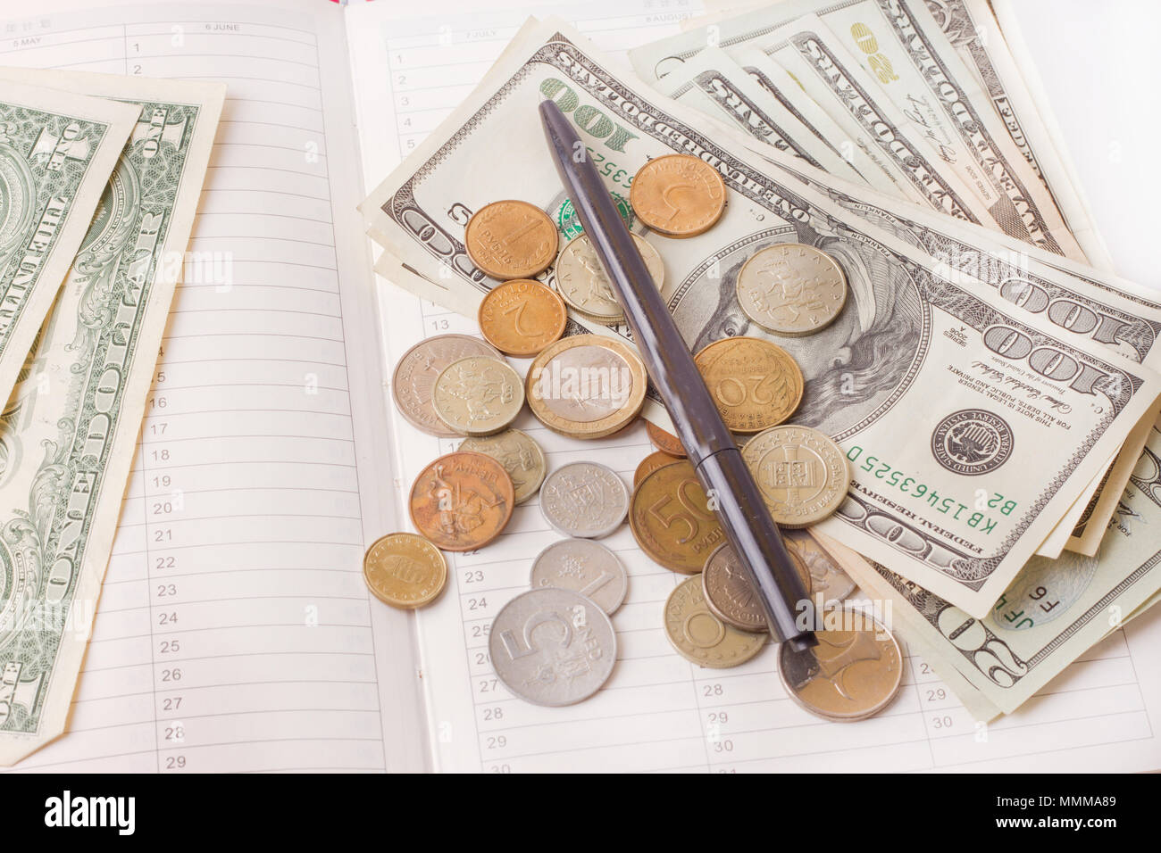 Diary with money and pen isolated on white background Stock Photo - Alamy