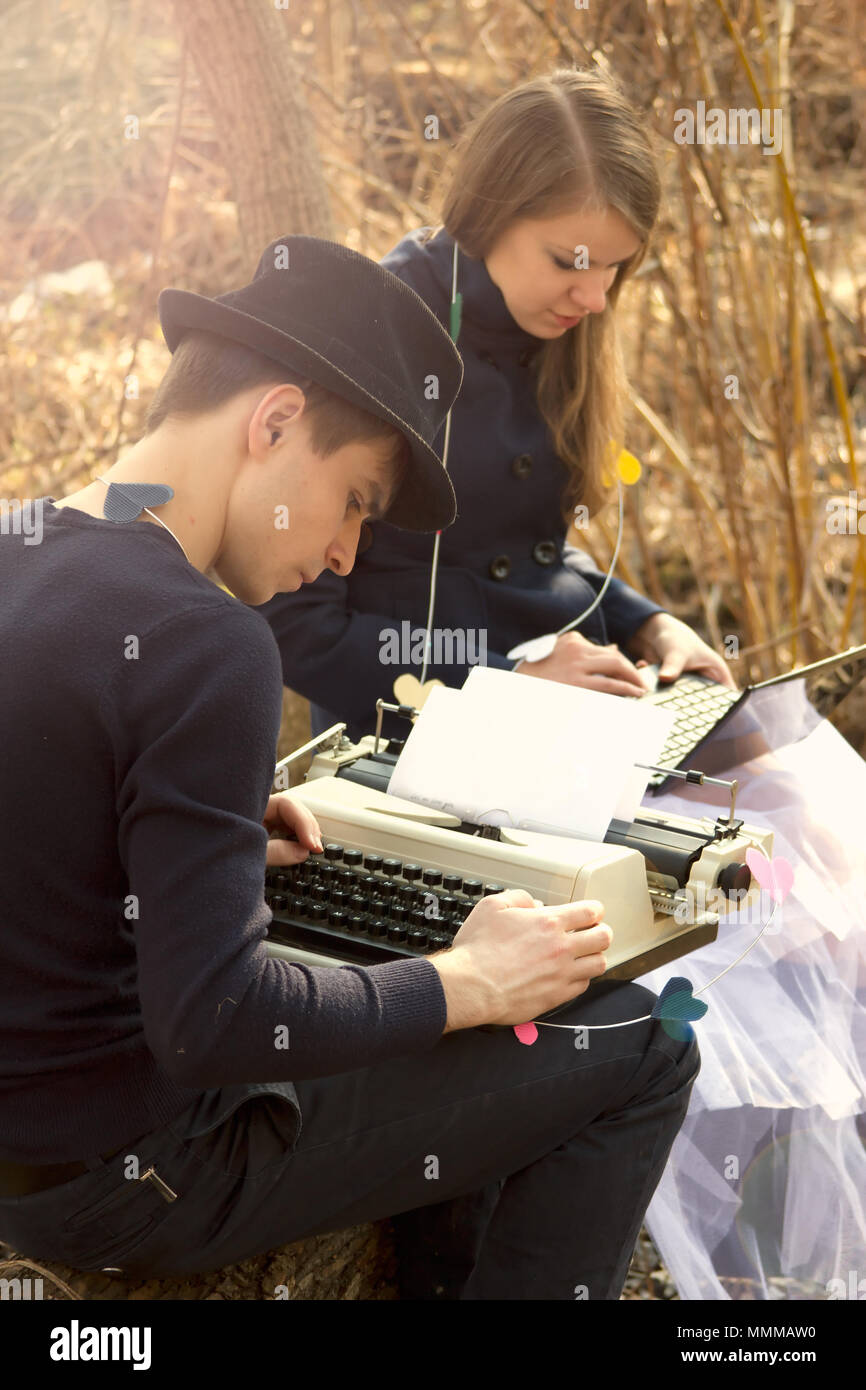 Young couple freelance typing on an old typewriter in the square Stock ...