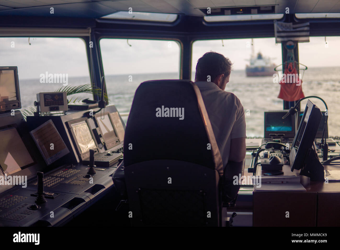 Deck navigation officer on the navigation bridge. He looks at radar ...