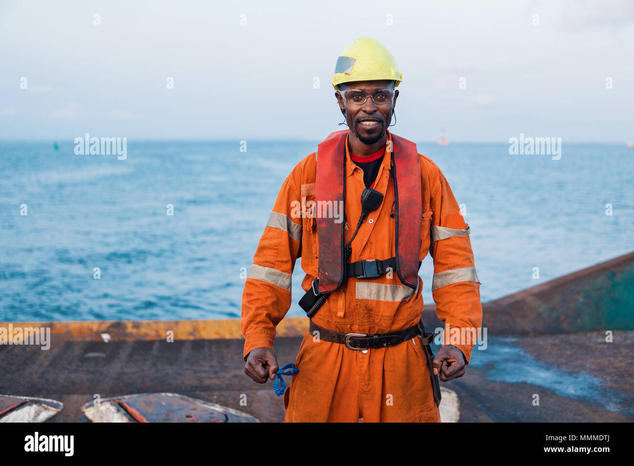 Seaman AB or Bosun on deck of offshore vessel or ship , wearing PPE ...