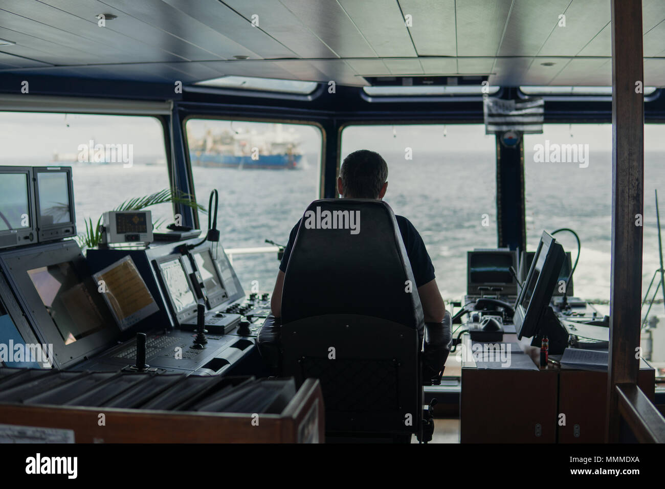Deck navigation officer on the navigation bridge. He looks to sea ...
