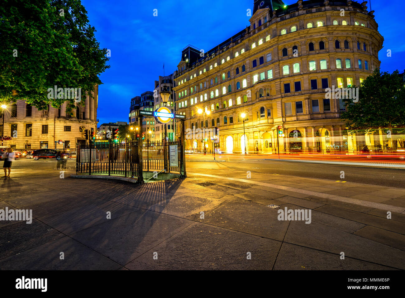 Cars and buses cause streaks across the night sky in front of Trafalgar ...