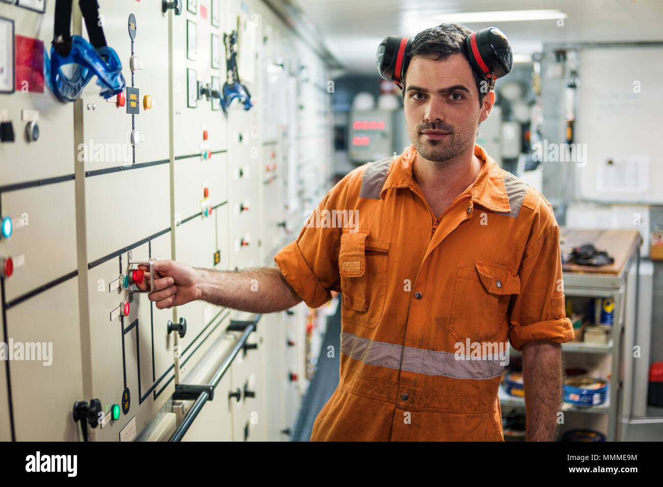 Marine engineer officer starts or stops main engine of ship in engine ...