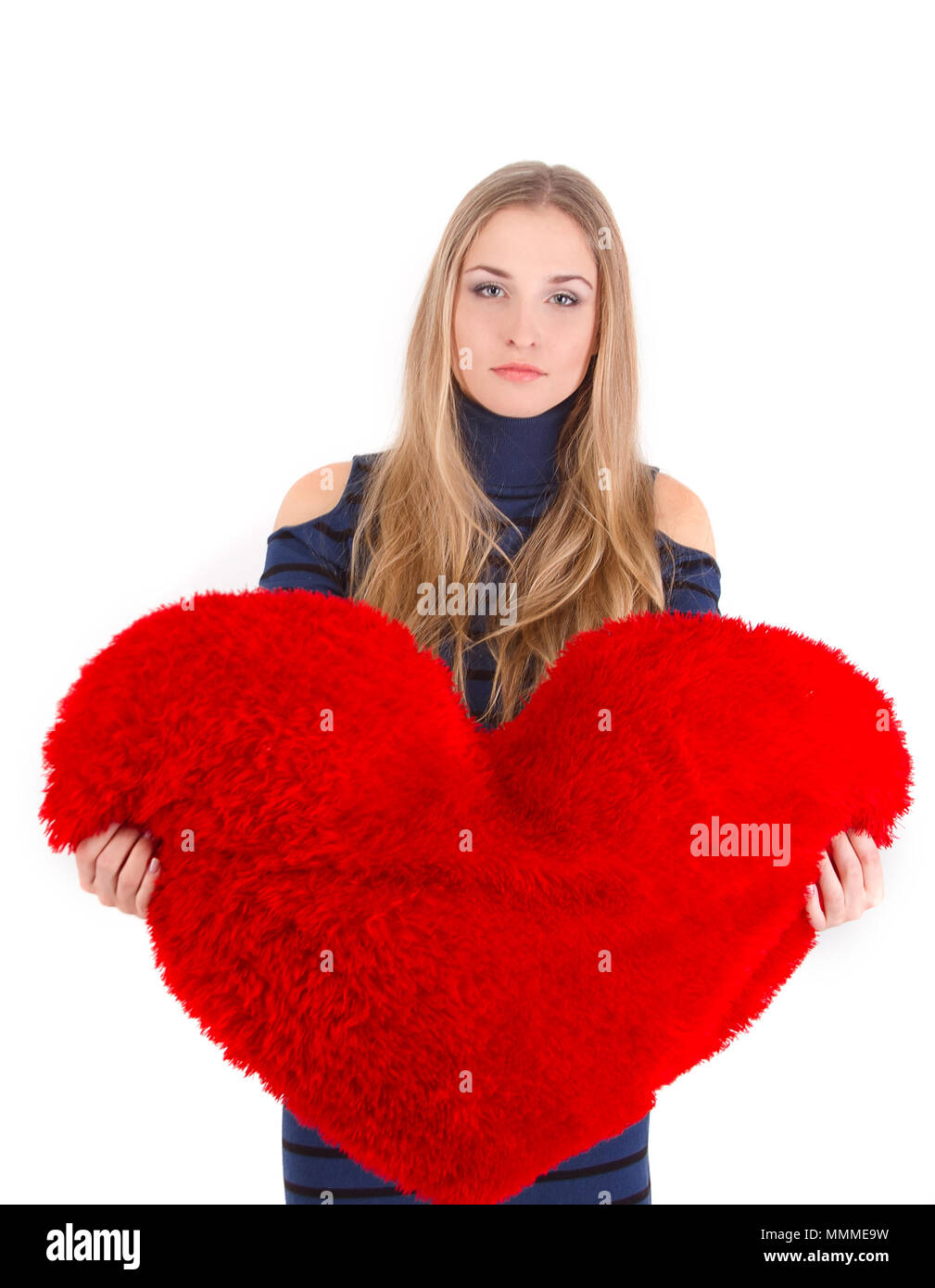 Young beautiful girl hugs a big soft heart. Feast of St. Valentine's ...