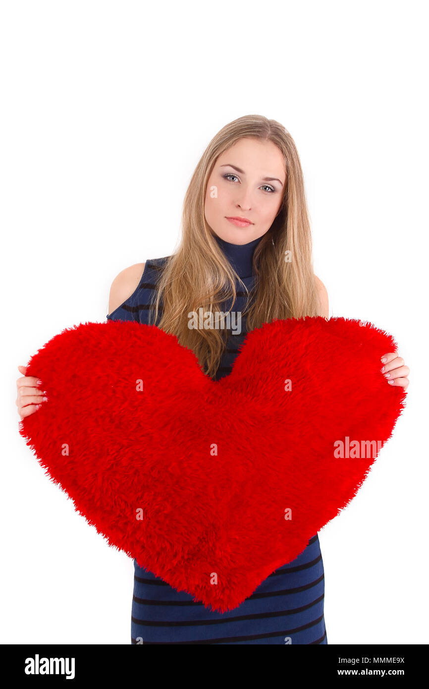 Young beautiful girl hugs a big soft heart. Feast of St. Valentine's ...