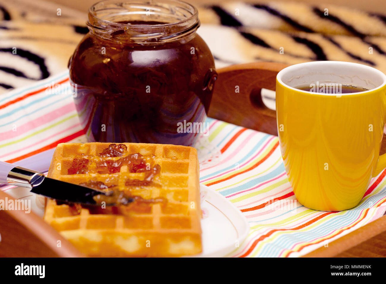 Breakfast - waffles, jam and a cup of tea Stock Photo - Alamy