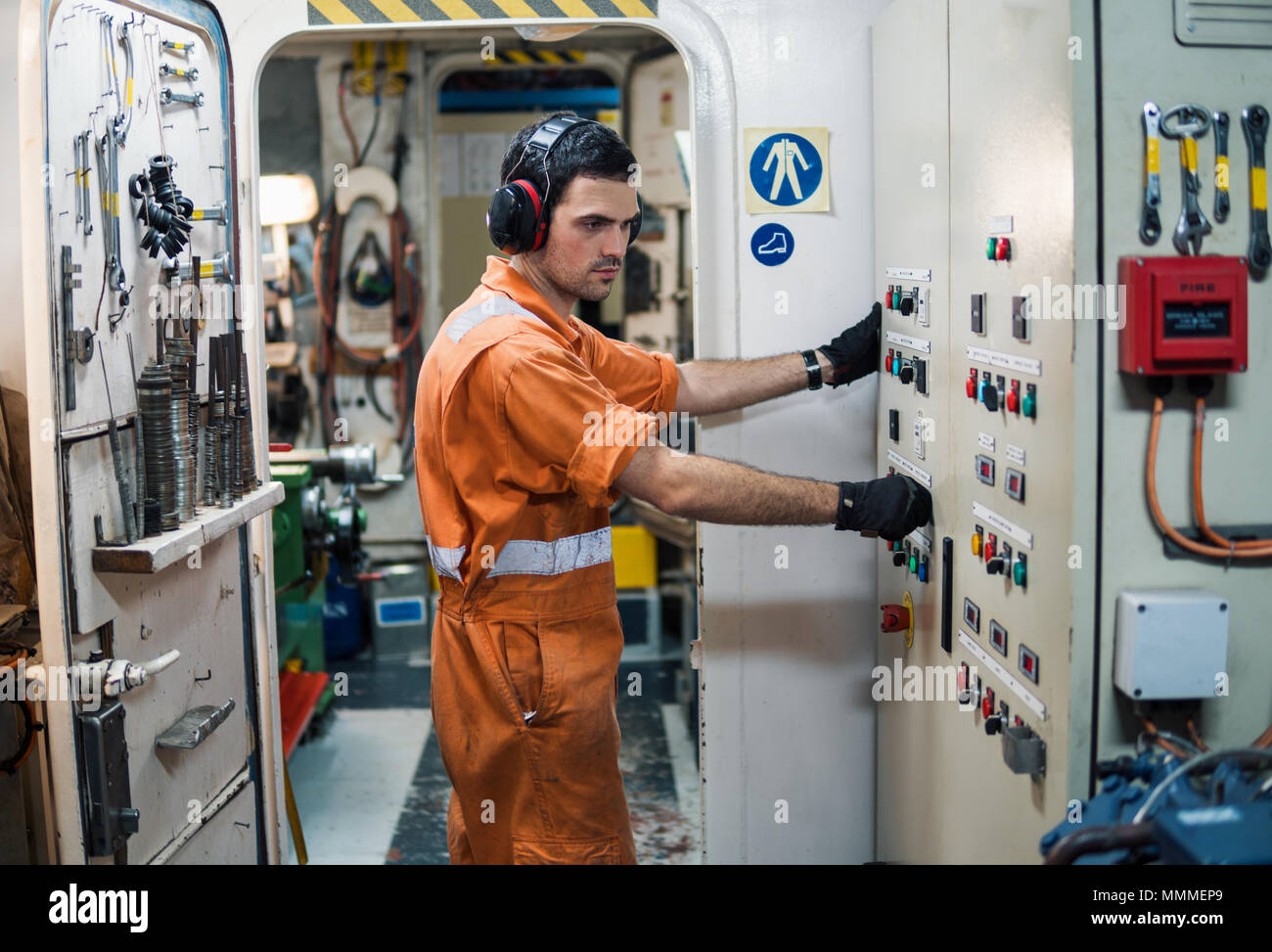 Marine engineer officer controlling vessel engines and propulsion in ...