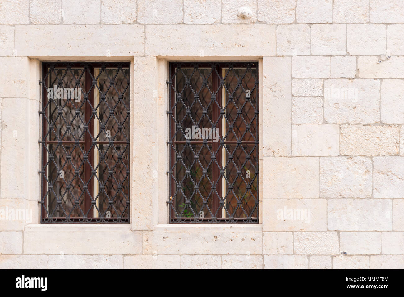 two window with a medieval-style grille in the castle Stock Photo - Alamy