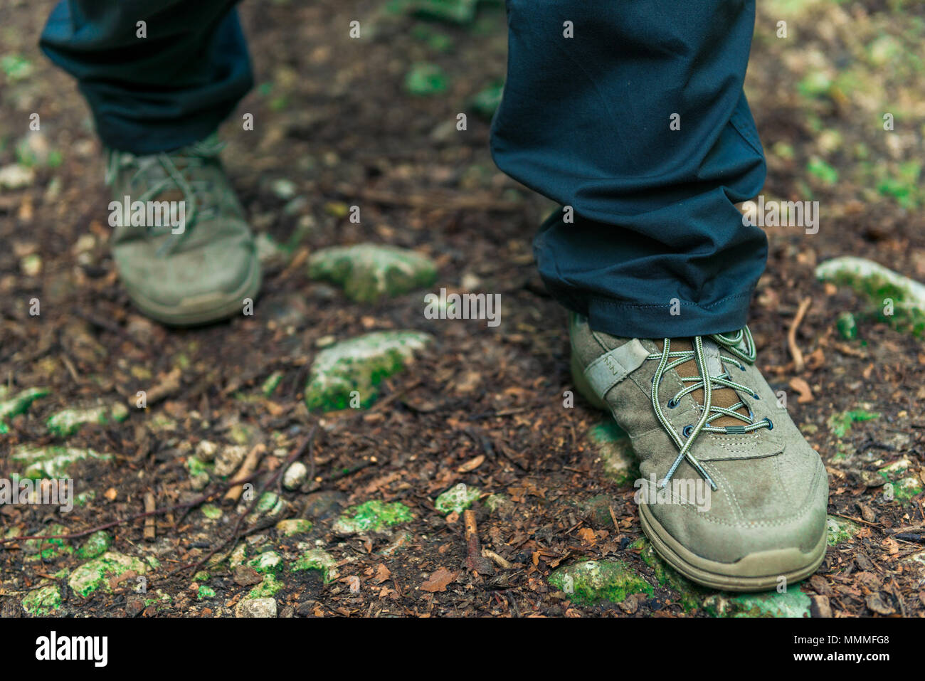 feet of a tourist in boots on a trail in the woods close-up Stock Photo ...