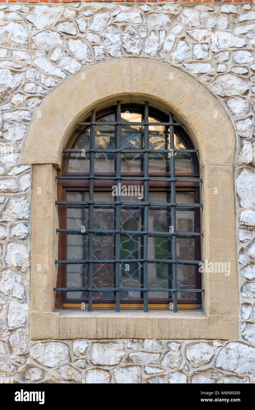 window with a medieval-style grille in the castle Stock Photo - Alamy