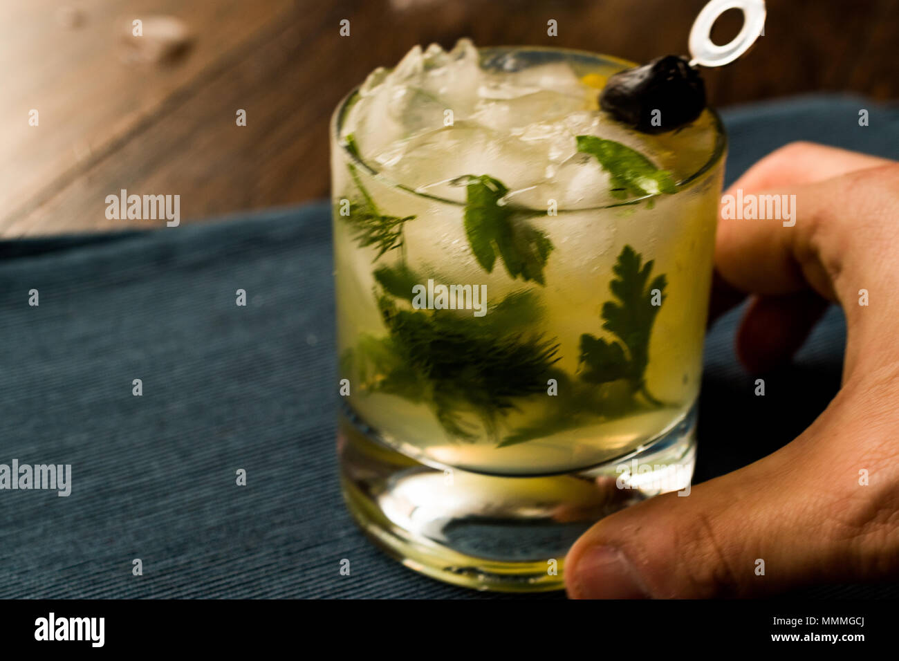 Dillionaire Cocktail with Dill, Gin, Parsley, lemon, Olive and Crushed ...