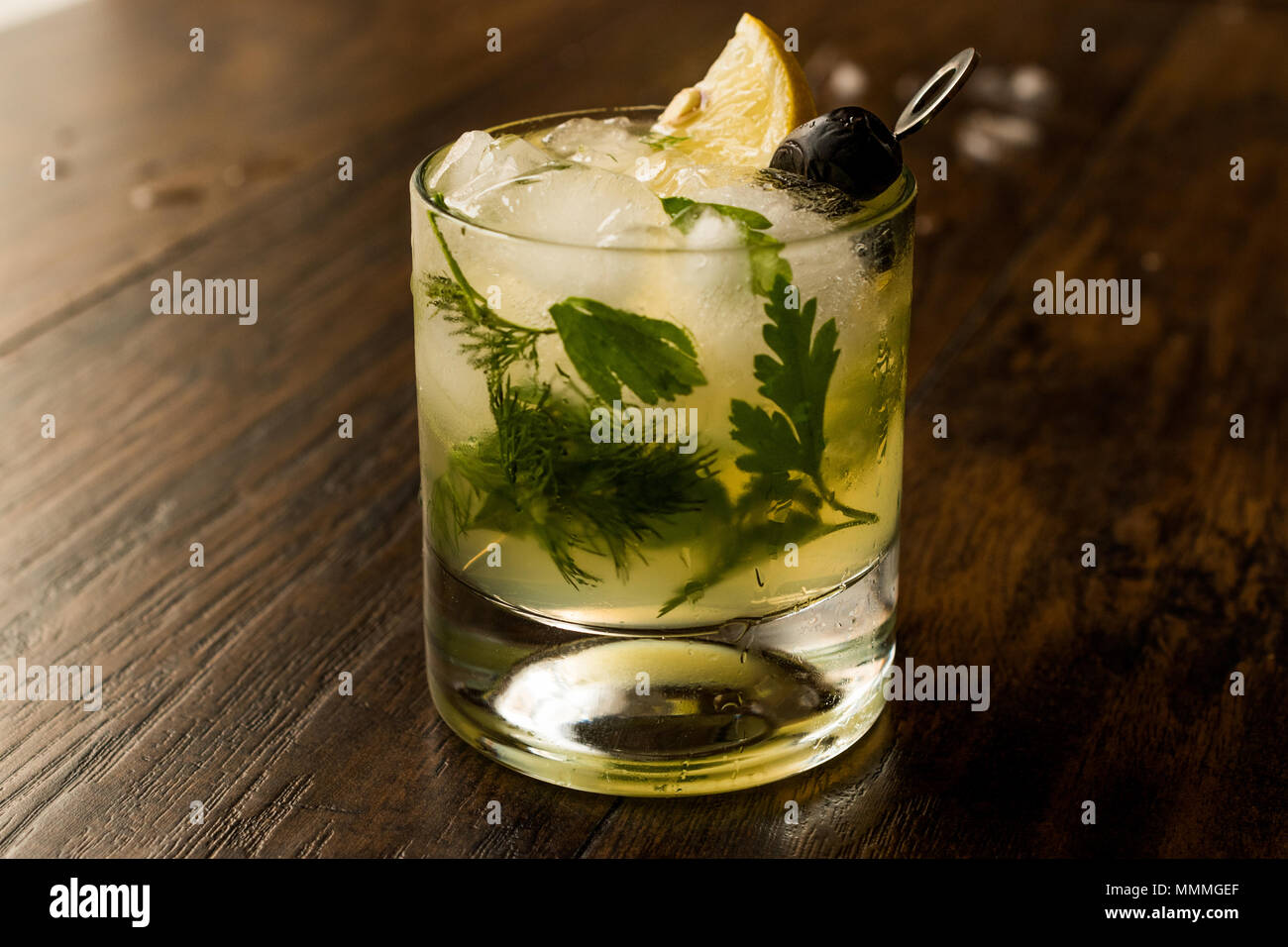 Dillionaire Cocktail with Dill, Gin, Parsley, lemon, Olive and Crushed ...