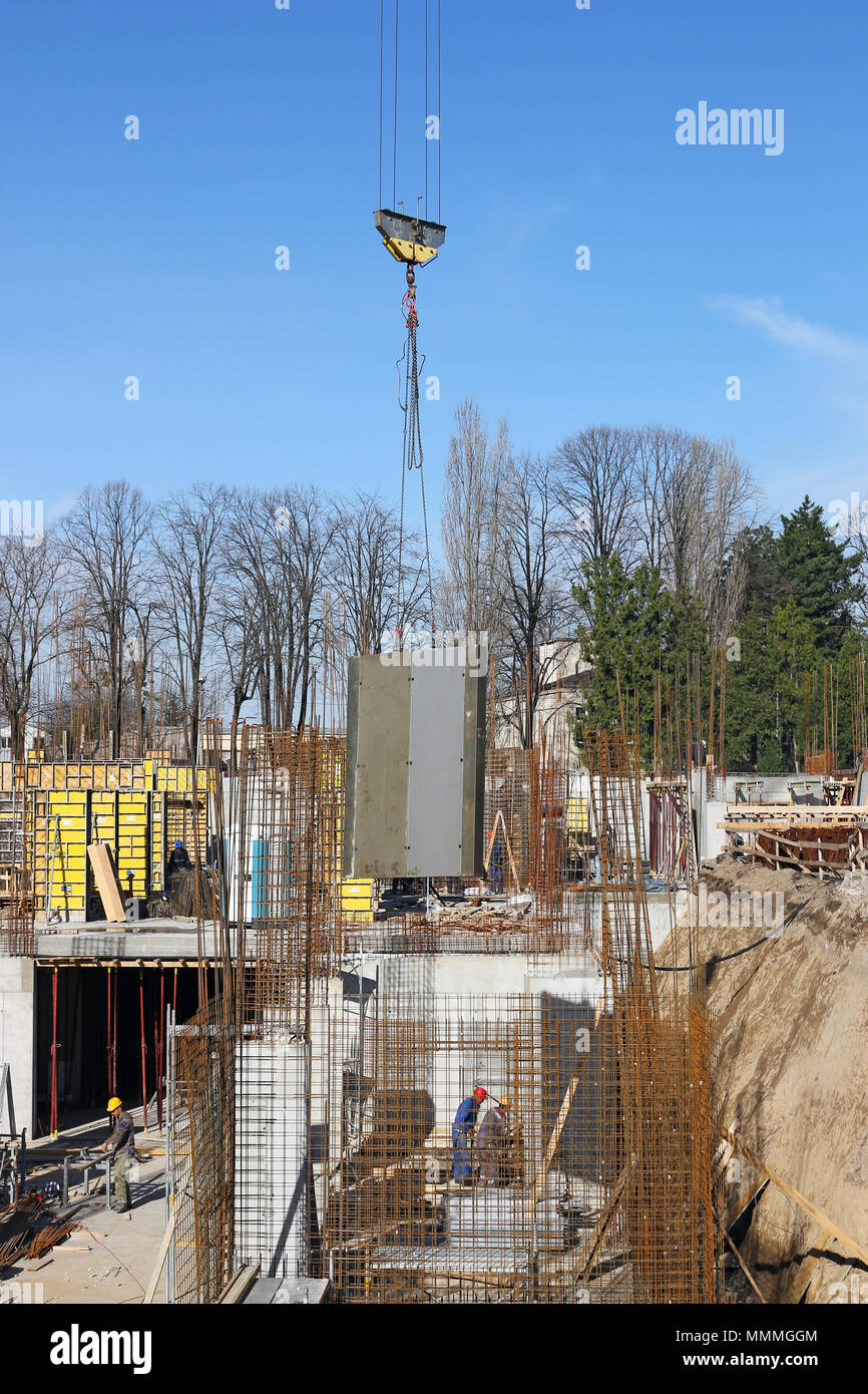 crane carry construction material on new building construction site ...
