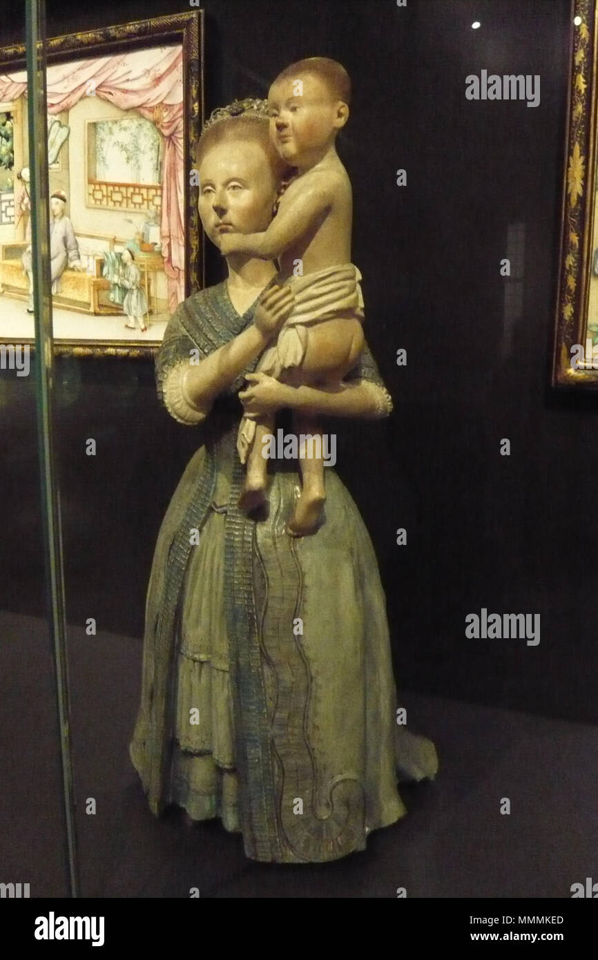 . Porcelain sculpture of a fashionable western lady holding a child ...