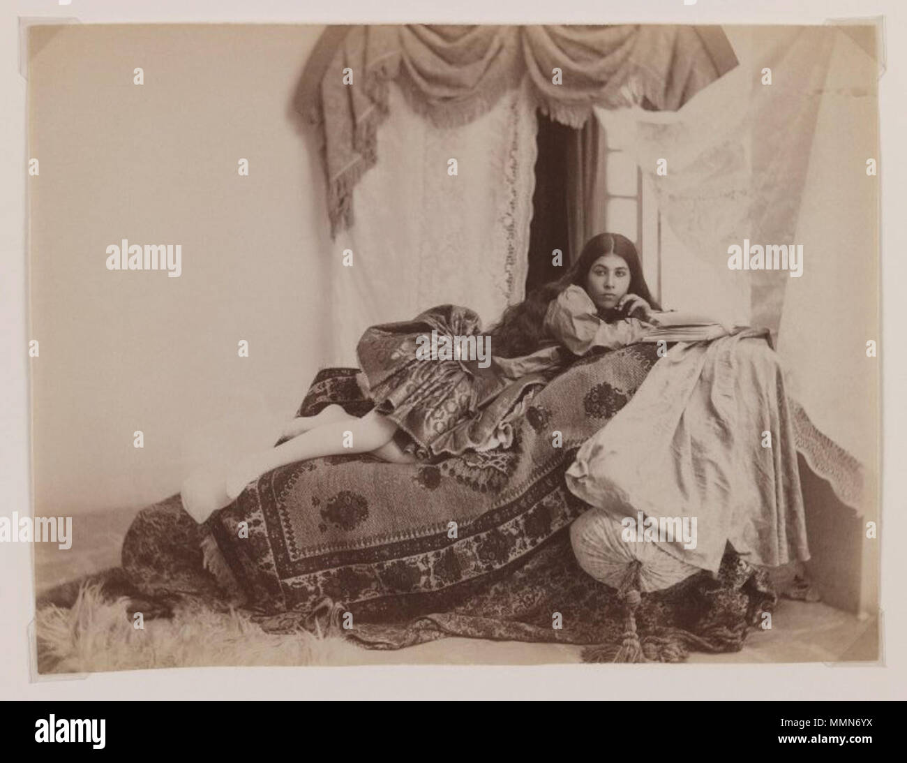 Studio Shot of a Reclining Lady Reading a Book. between 1800 and 1899 ...