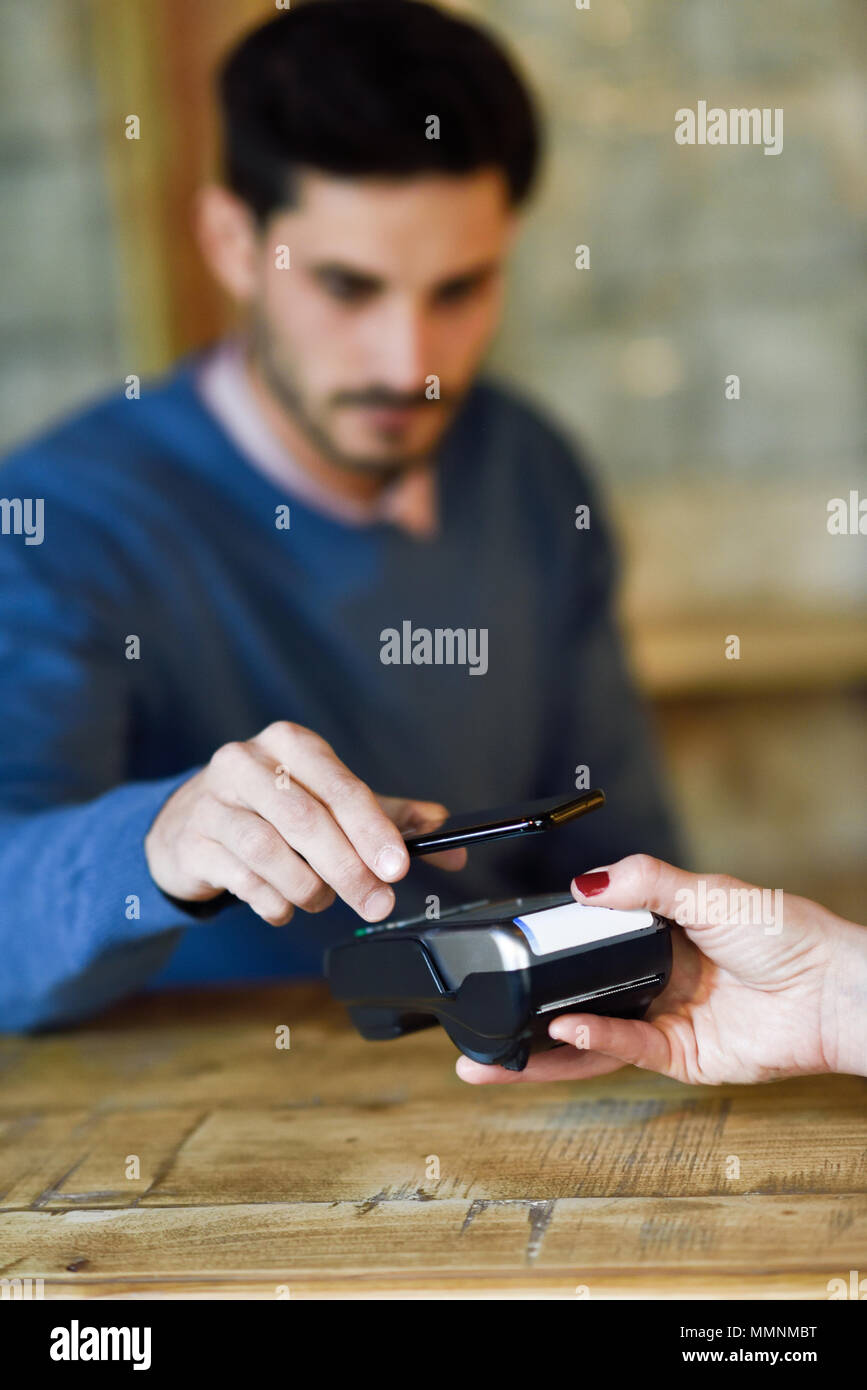 NFC Near Field Communication Mobile Payment. Hand holding smartphone ...