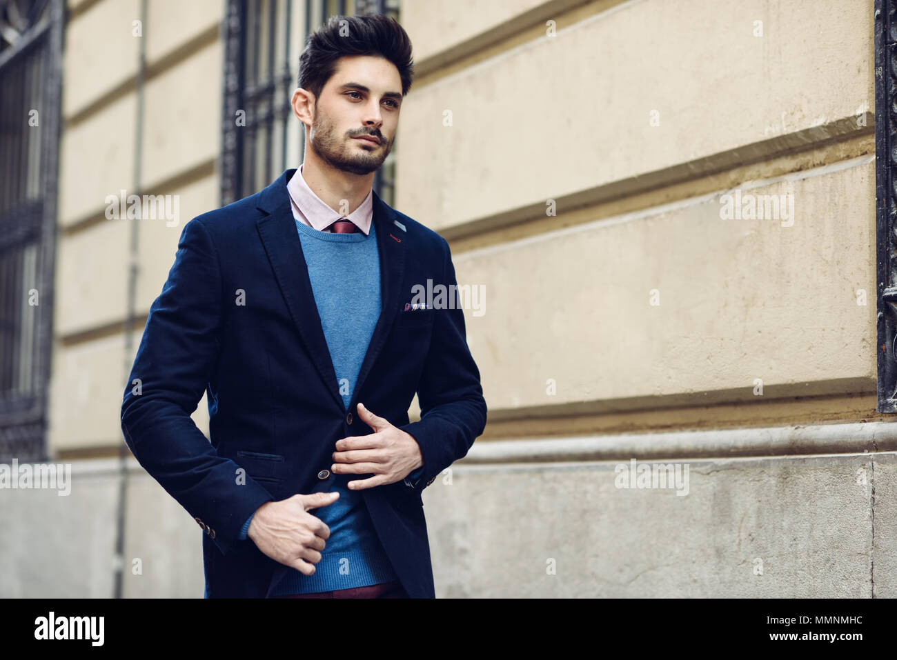 Attractive man in the street wearing british elegant suit. Young ...