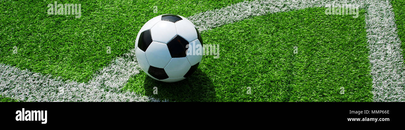 soccer ball on green ground, panoramic format, landcape format on ...