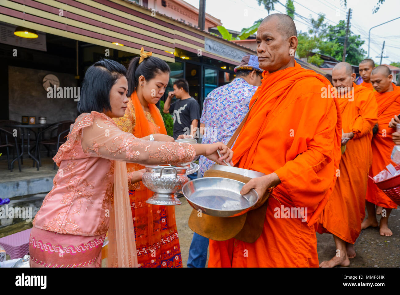 Kanchanaburi, Thailand - July 23, 2016: People offering food and things ...