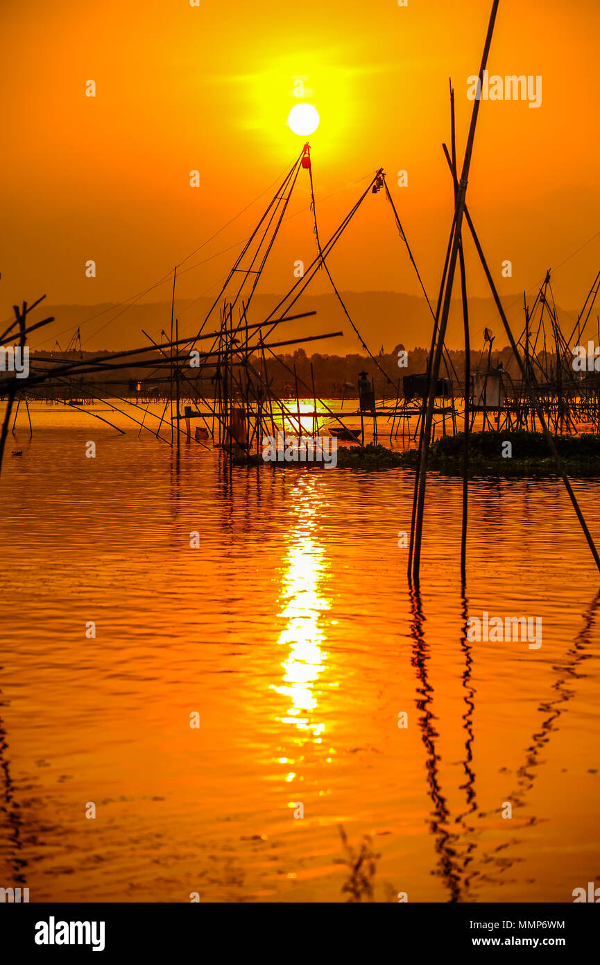 Traditional bamboo and wooden fishing tools installed in rural swamp ...