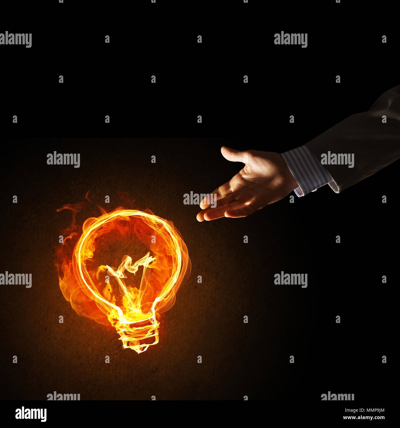 Close of businessman hand showing at glowing fire light bulb icon Stock ...