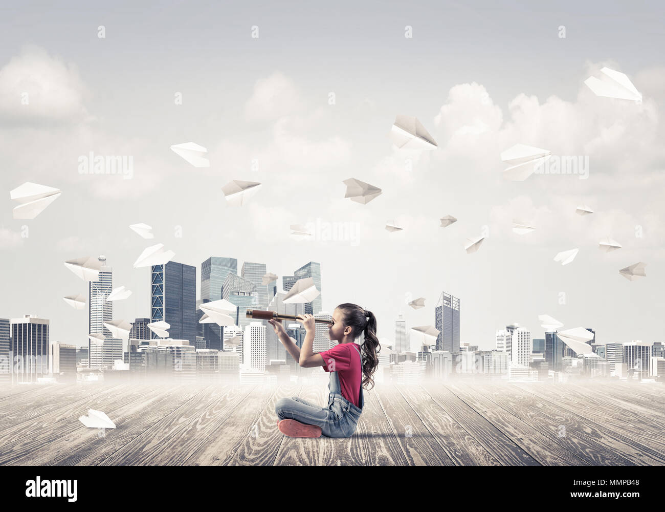 Cute kid girl sitting on wooden floor and paper planes flying around ...