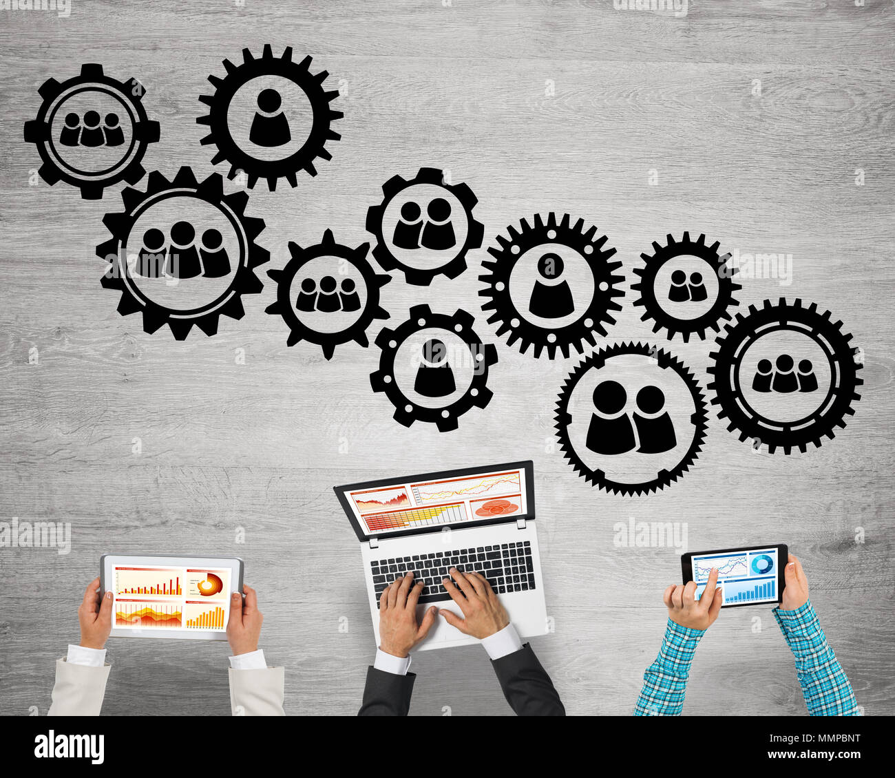 Group of three people with devices in hands working together as symbol ...