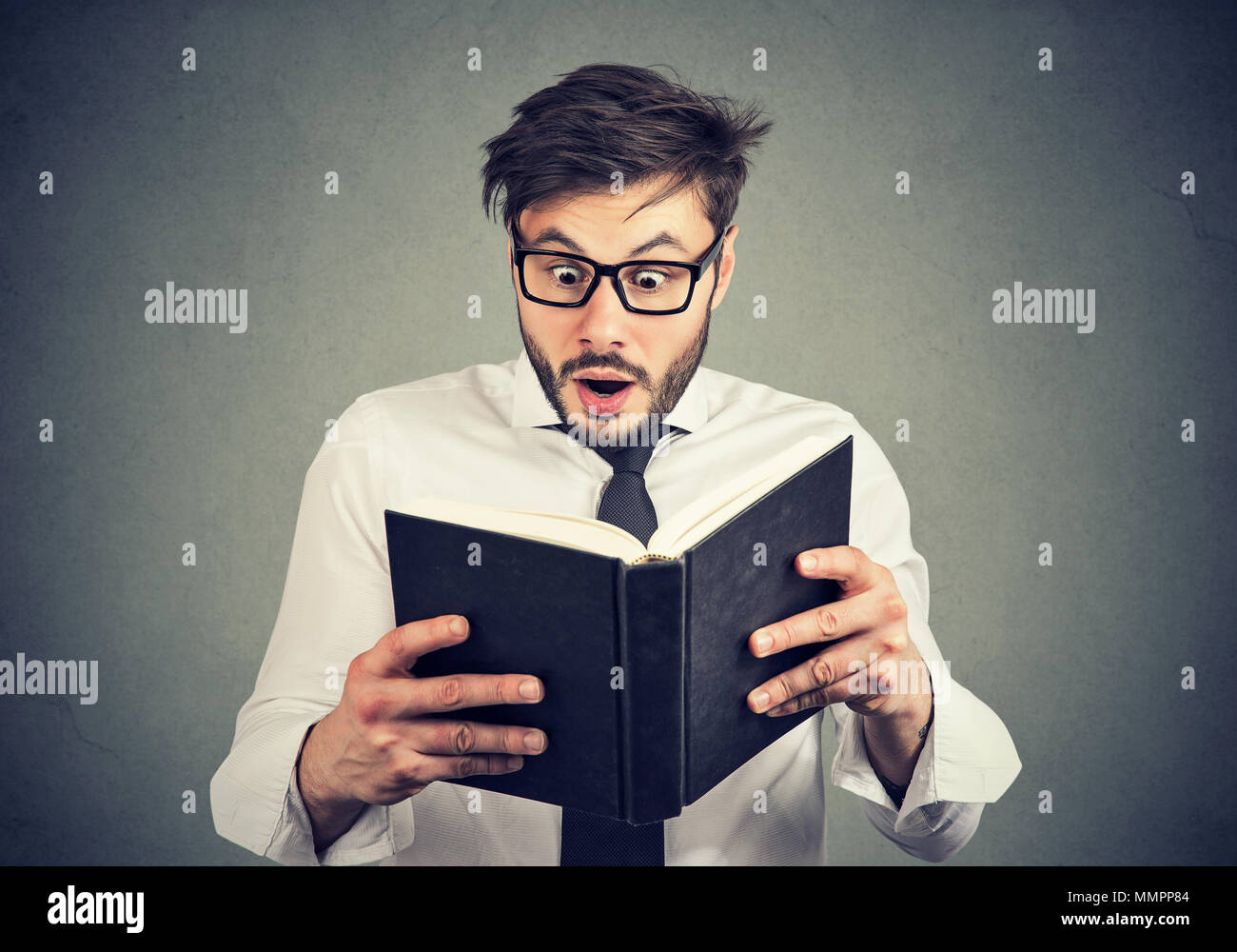 Bearded Handsome Man In Glasses Reading Book And Stunned With New