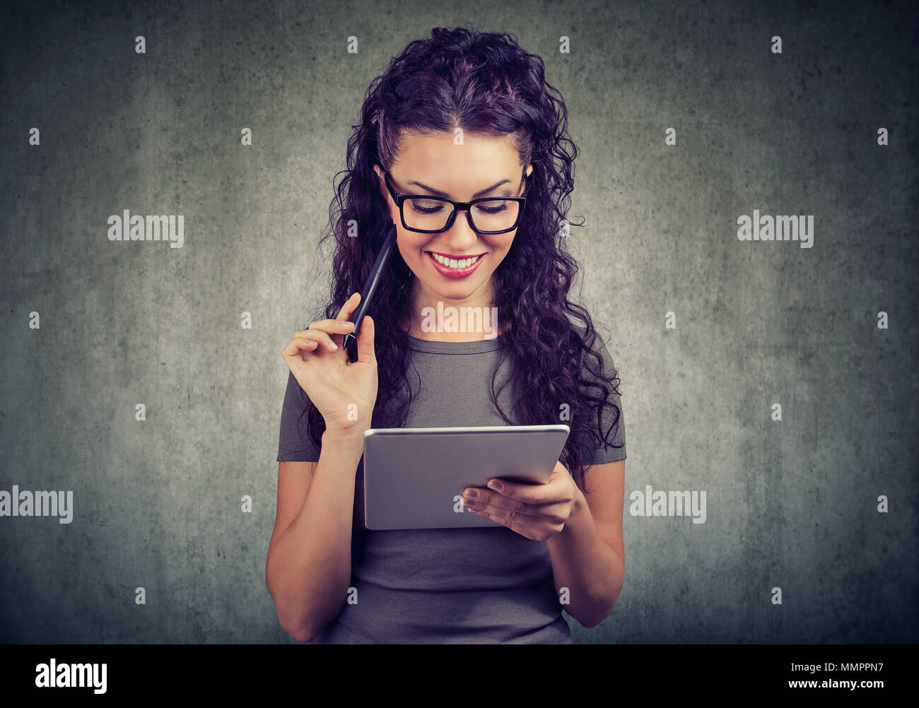 Happy woman with tablet computer and pen has an idea, brainstorming new ...