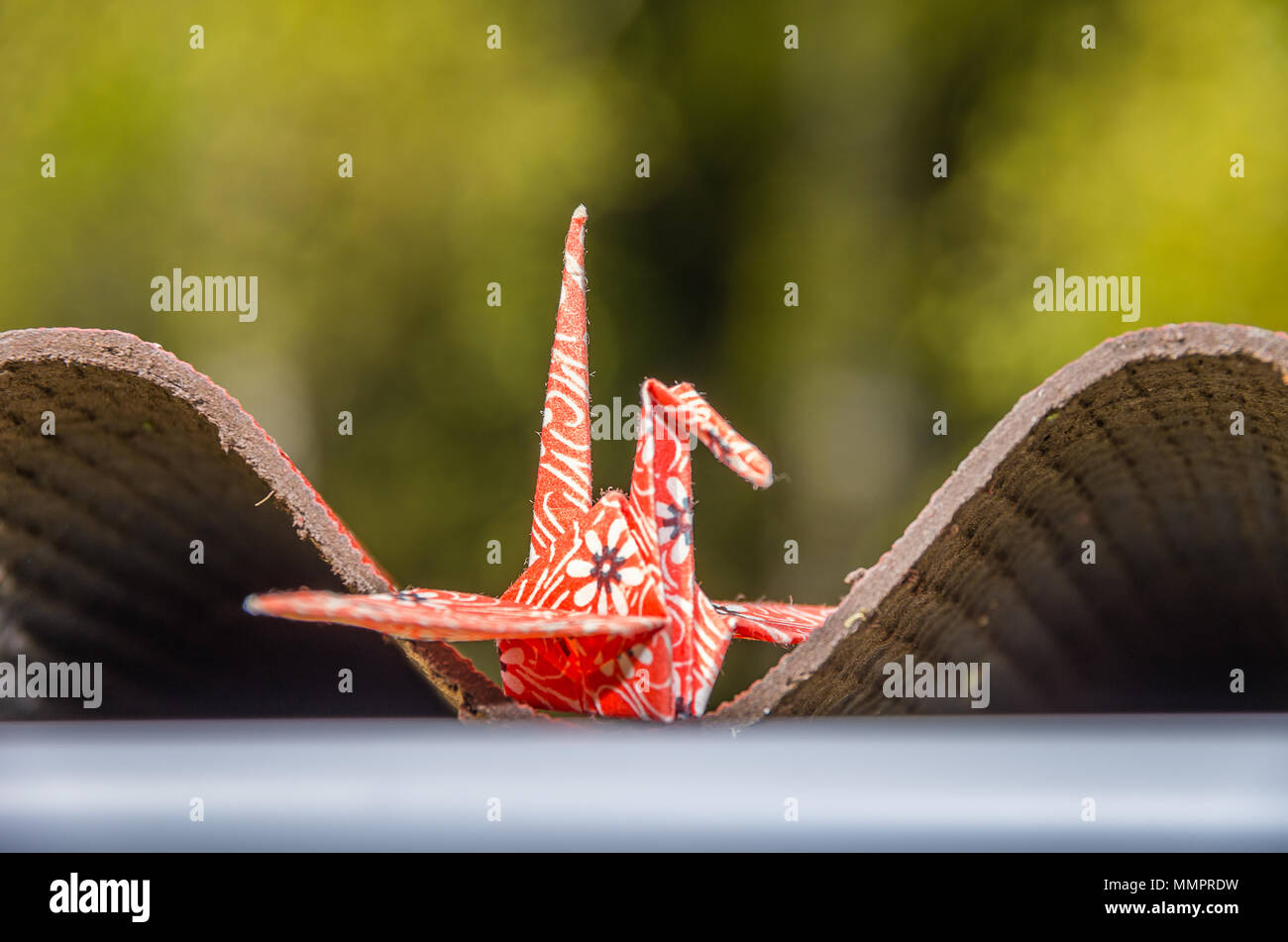 Origami paper crane made of original Japanese origami paper set up in a ...
