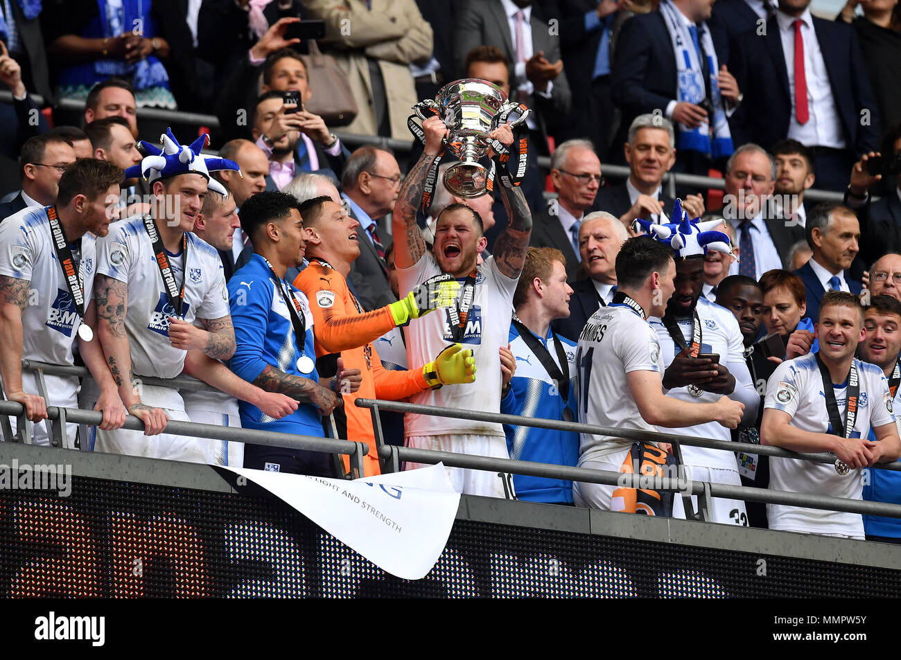 Tranmere Rovers' James Norwood lifts the trophy after the game during ...