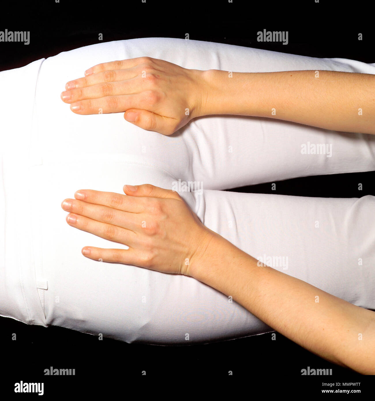Reiki therapy of a woman in a white shirt and black background, healing hands Stock Photo - Alamy