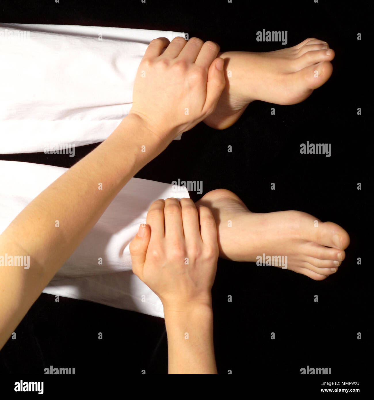 Reiki therapy of a woman in a white shirt and black background, healing hands Stock Photo - Alamy