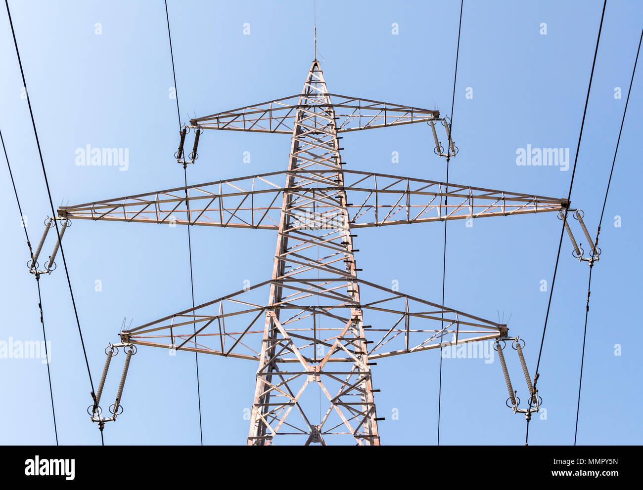 Electricity pillar high voltage line, blue sky background Stock Photo ...