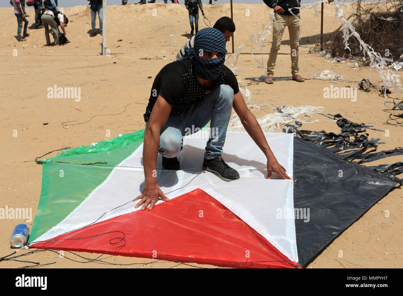 Palestinian demonstrators fly a kite carrying burning materials to set ...