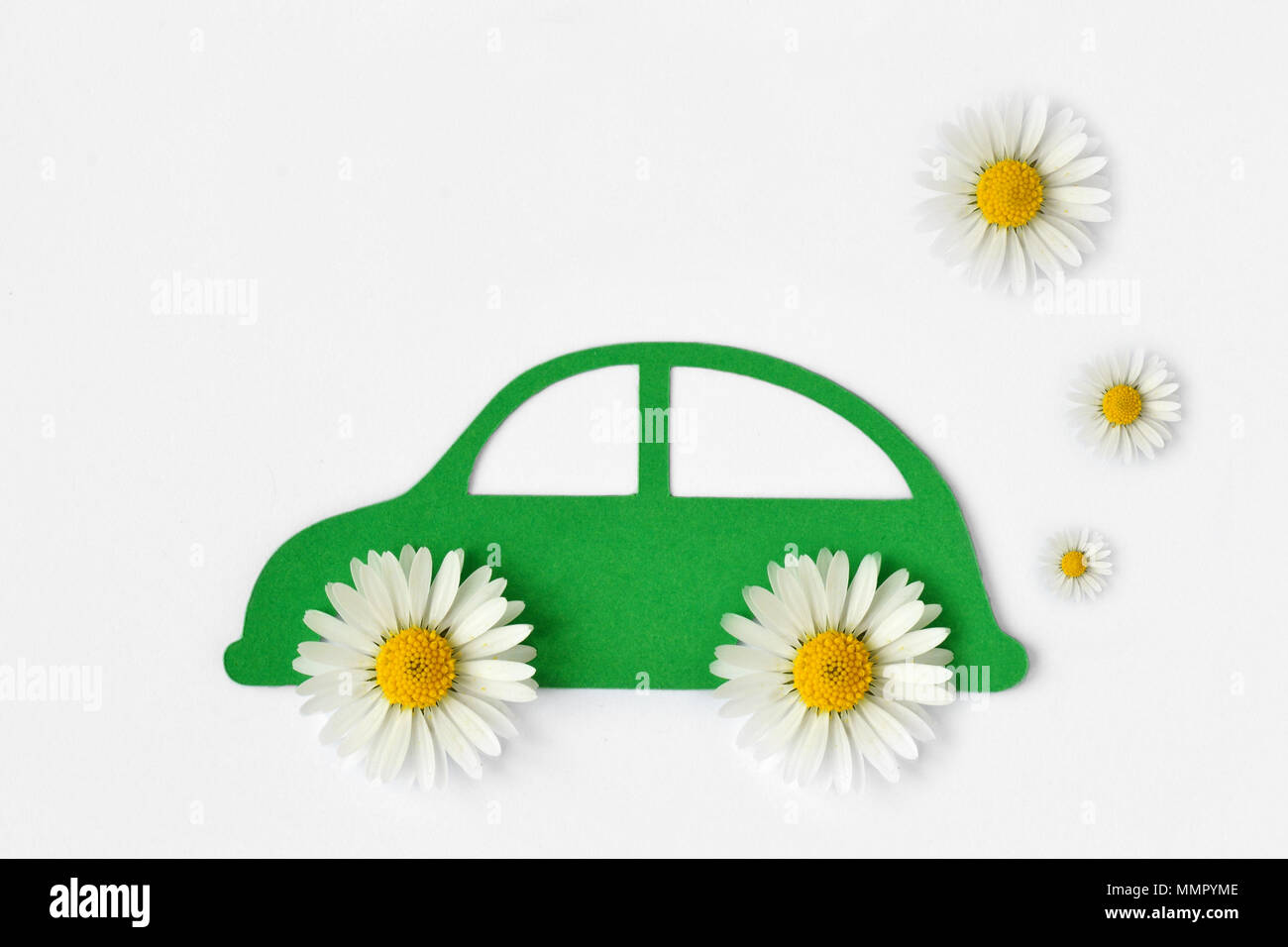 Paper car cut-out with daisy flowers on white background - Eco-friendly ...