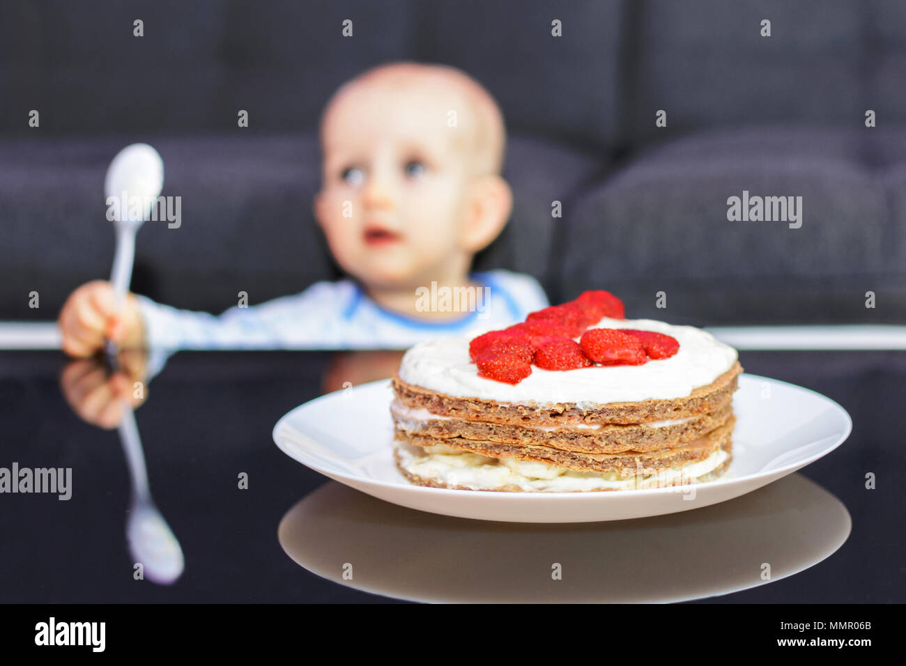First birthday celebration of a little boy. Little boy eating birthday ...