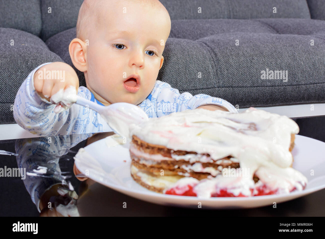 First birthday celebration of a little boy. Little boy eating birthday ...