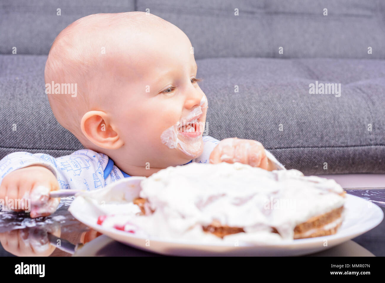 First birthday celebration of a little boy. Little boy eating birthday ...