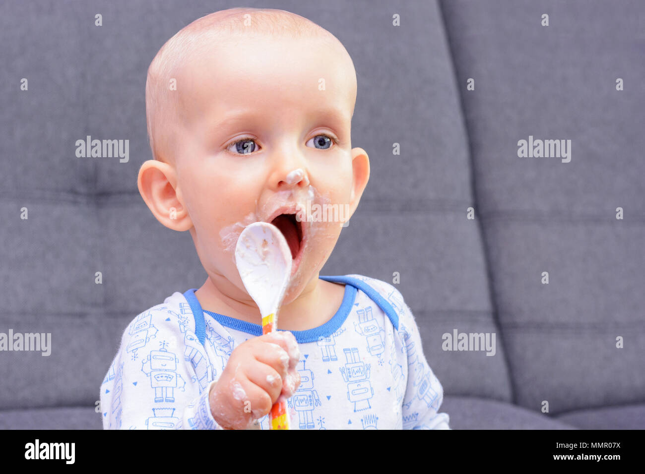 First birthday celebration of a little boy. Little boy eating birthday ...