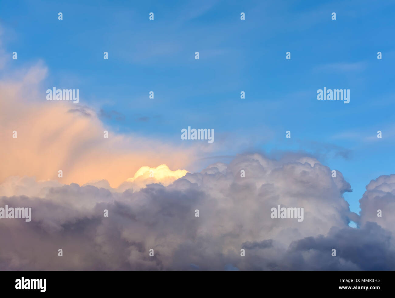 Cumulus clouds in the evening sunset sky Stock Photo - Alamy