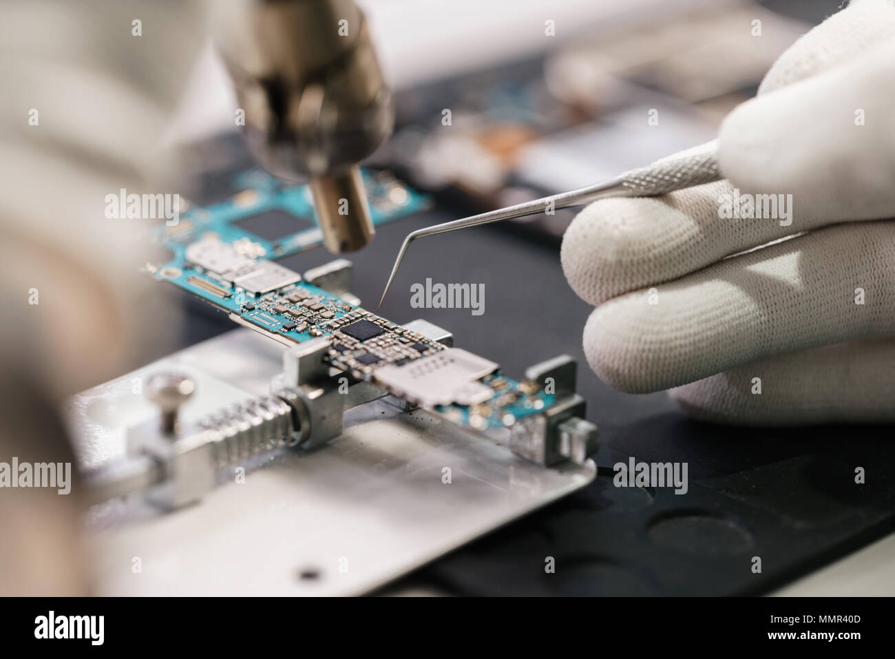 Work with a microscope. Microelectronics device. Close-up hands of a ...
