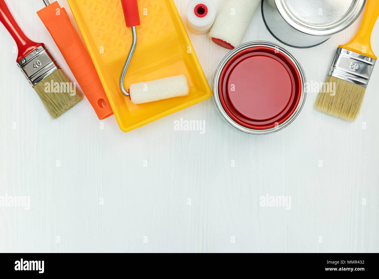 painting tools on white wooden background. paint cans, brushes and ...