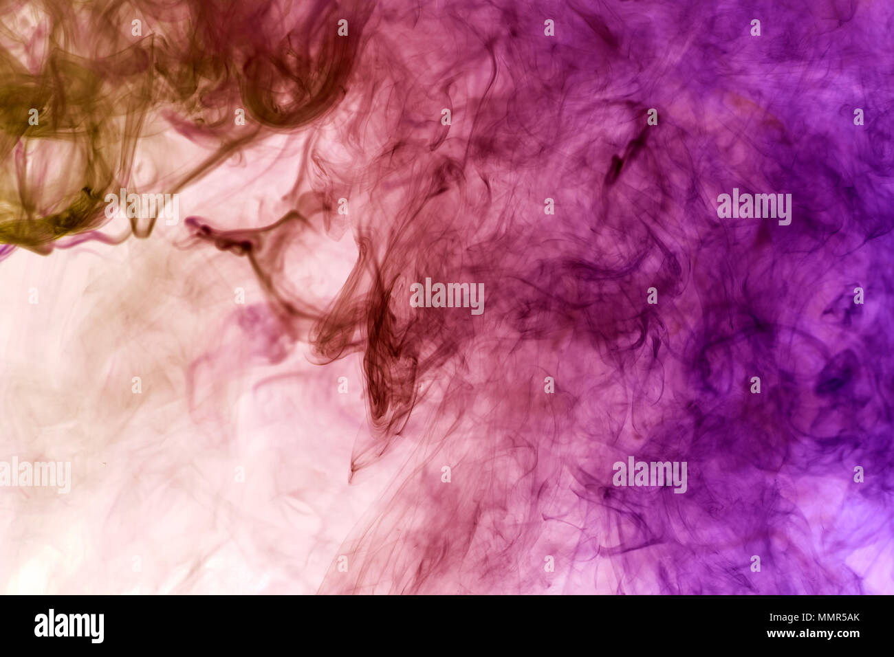 Thick colorful purple,red smoke on a white isolated background ...