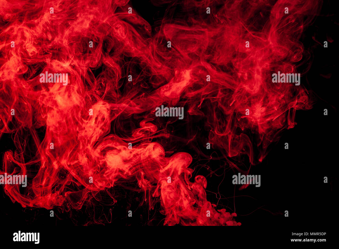 Thick colorful red smoke on a black isolated background. Background ...