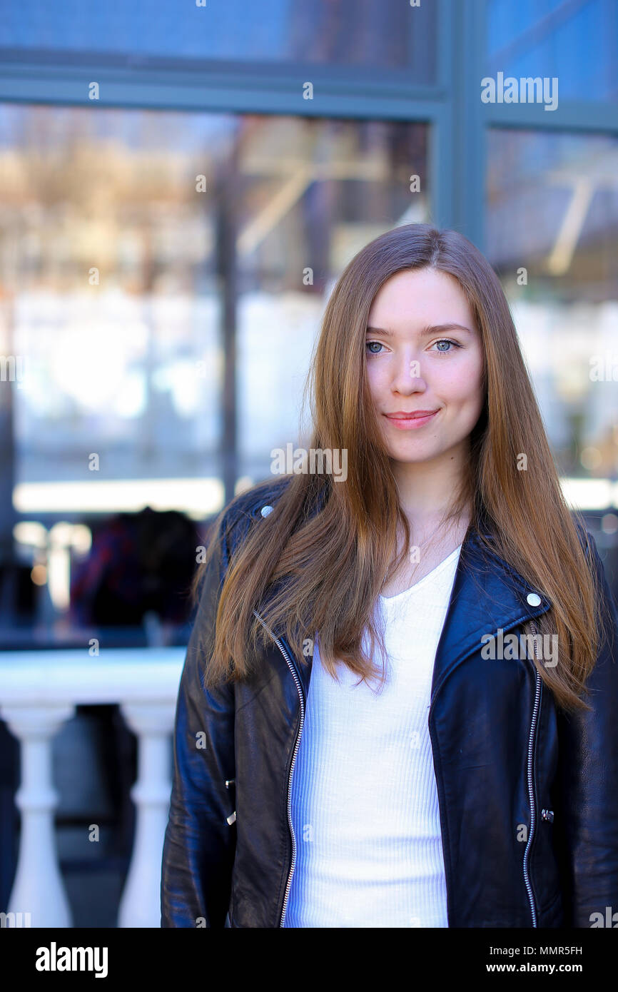 Cute girl standing near window in city Stock Photo - Alamy