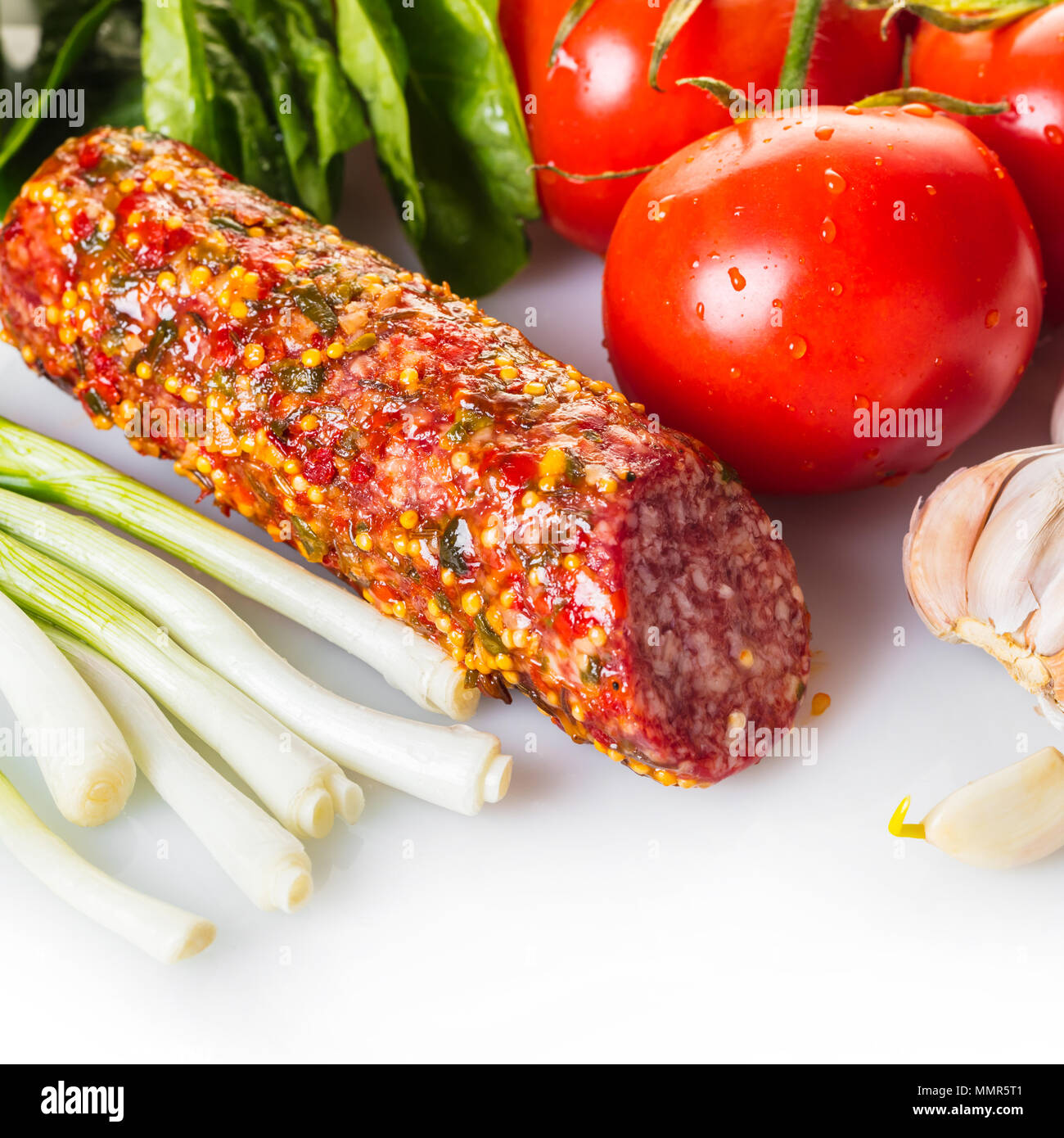 stick salami with vegetables on a white background Stock Photo - Alamy