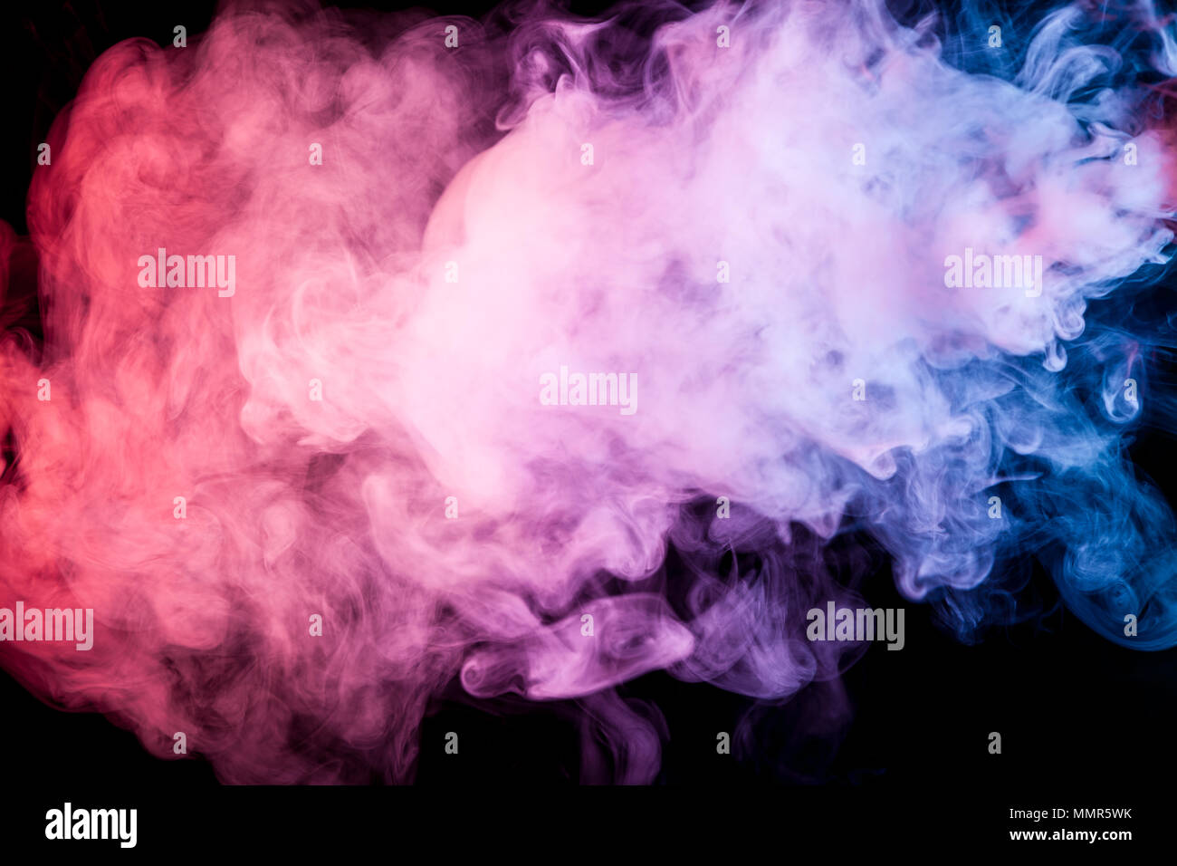 Colorful pink, blue and red smoke on a black isolated background ...
