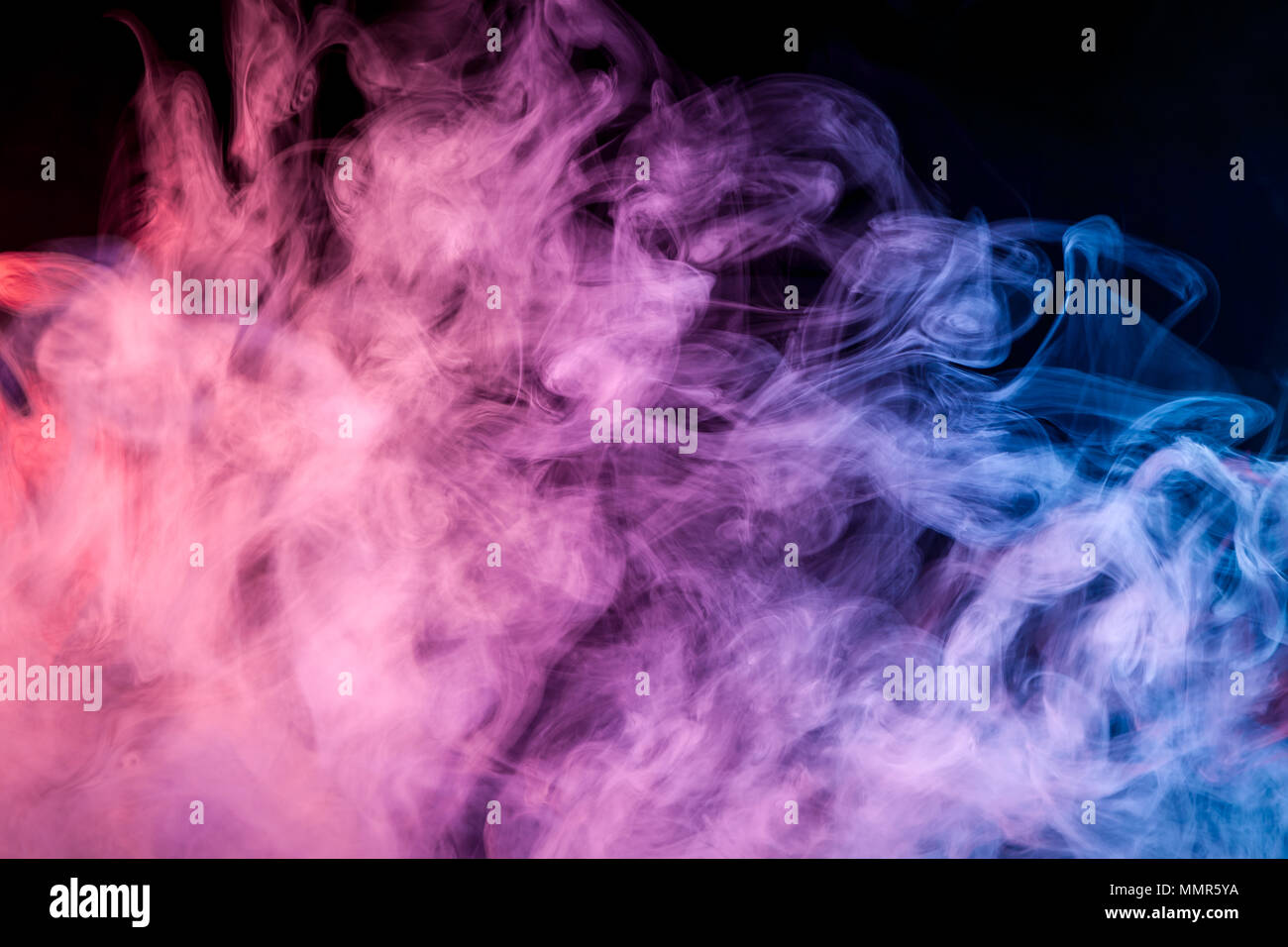 Colorful pink, blue smoke on a black isolated background. Background ...